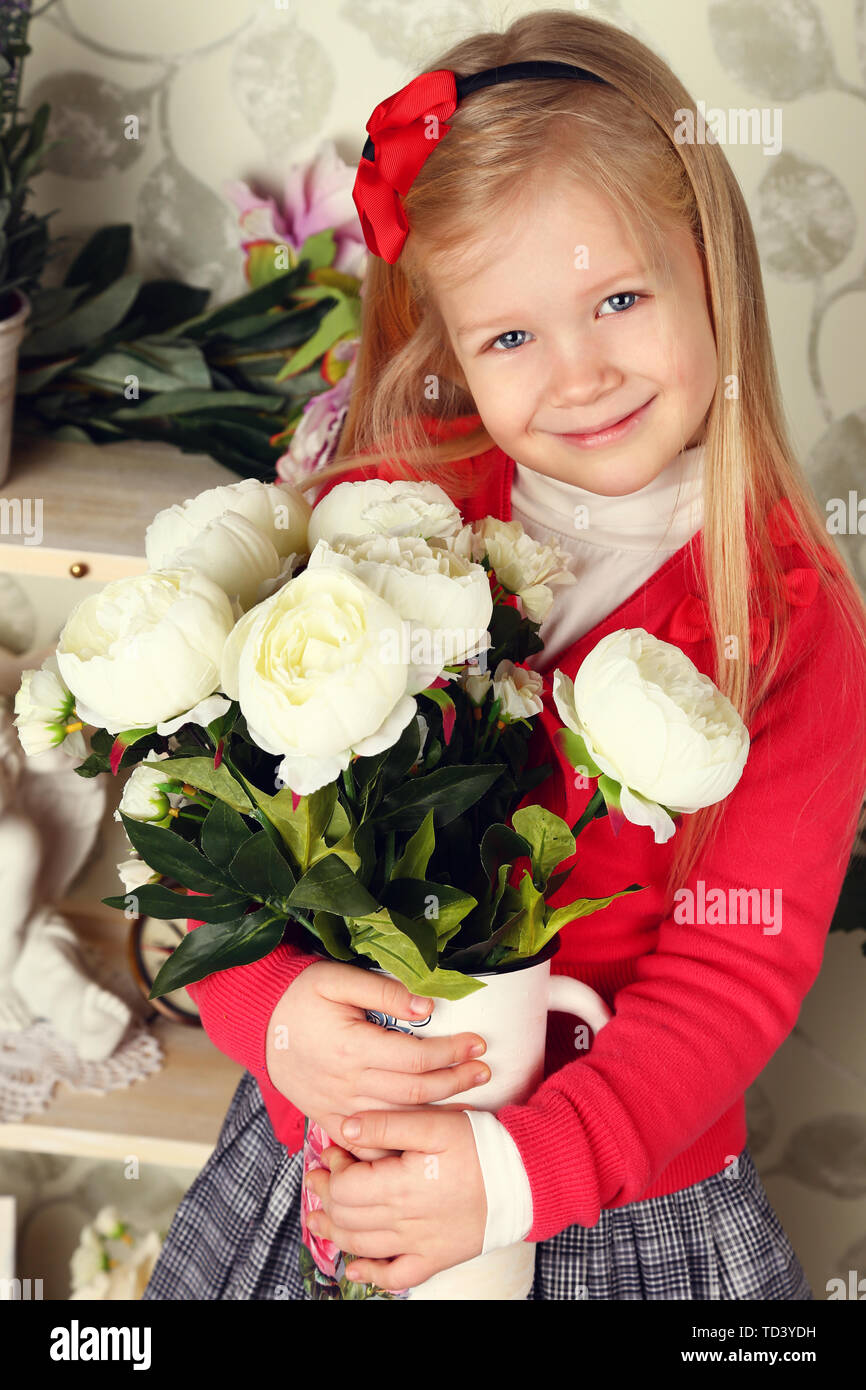 Cute little child girl with spring flowers, happy baby girl with basket ...