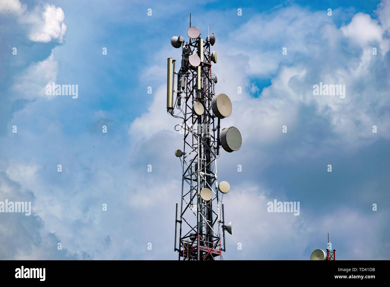 Telecom tower with lots of aerials and antennas mounted on it against ...