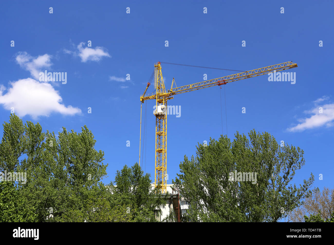 Yellow and blue tower crane hi-res stock photography and images - Alamy