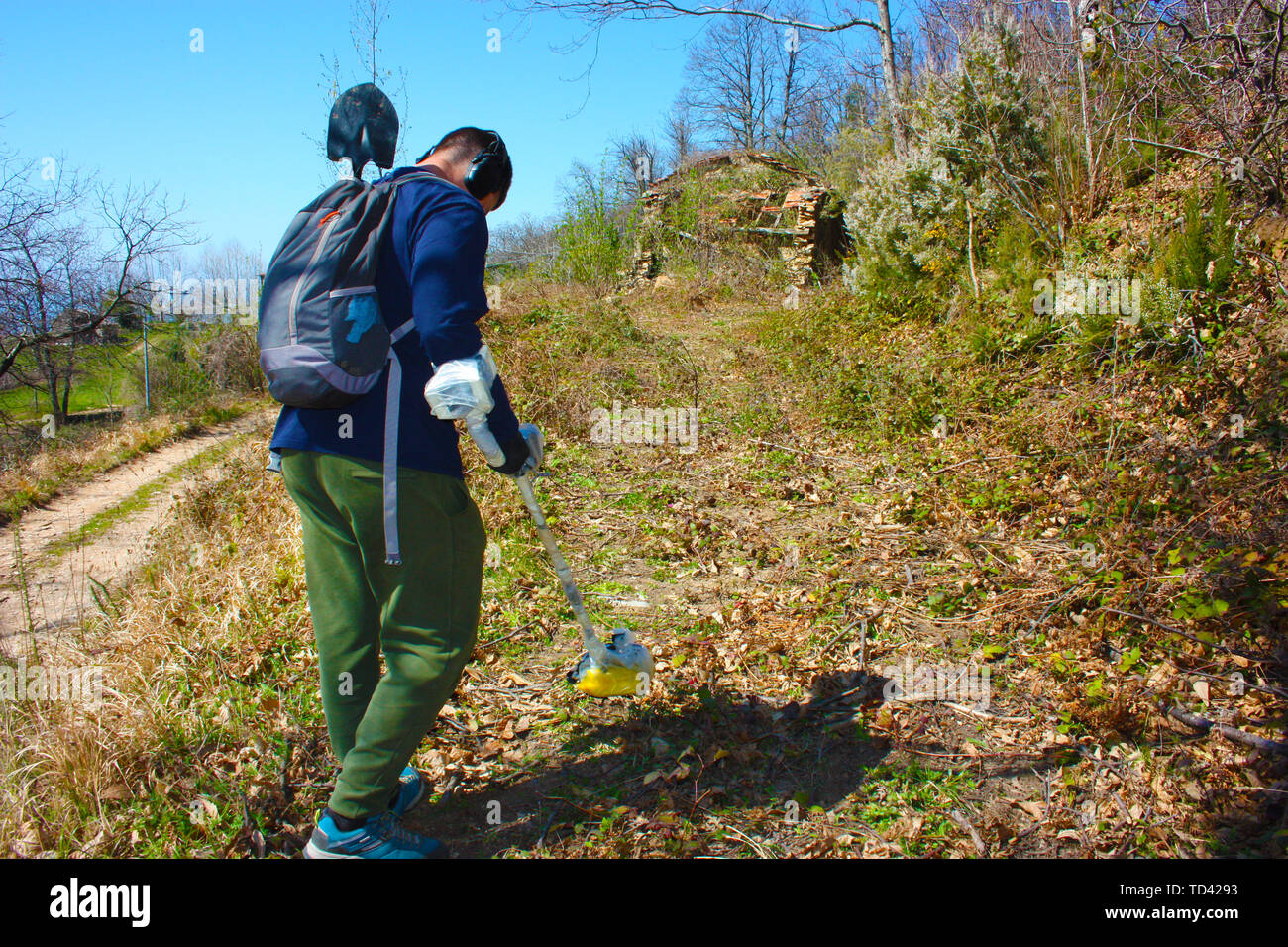 young man immersed in nature dedicates himself to his hobby, searching ...
