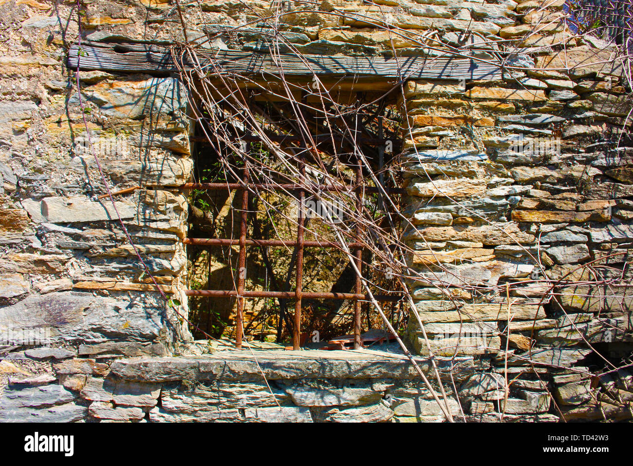 old rusty railings of a very old missing window, belonging to a ...