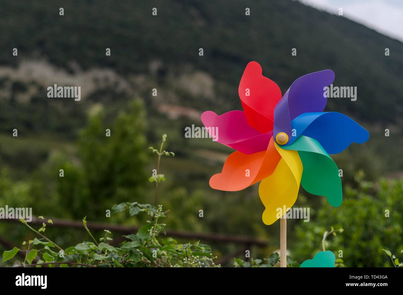 Colorful windmill with countryside in the background Stock Photo - Alamy
