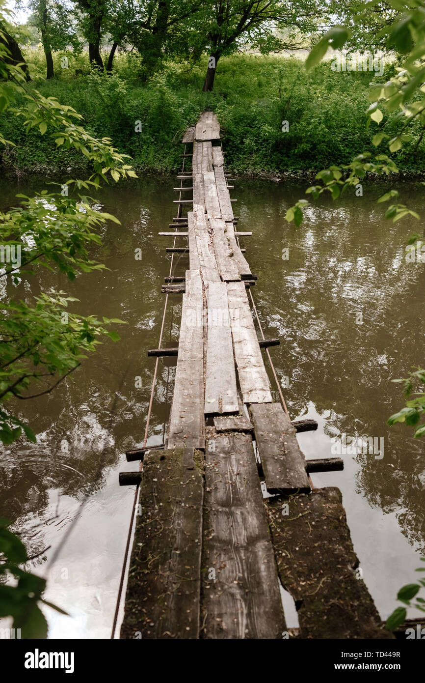 Old wooden bridge, wooden bridge across a small river, bridge with ...