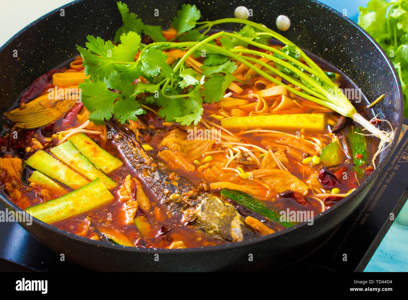 Red oil roast fish hotpot Stock Photo - Alamy