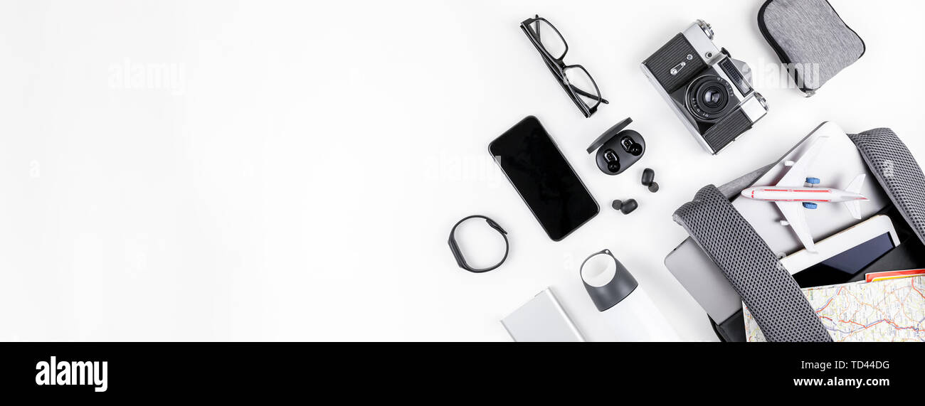 Creative top view flat lay of open backpack with laptop and tablet ...