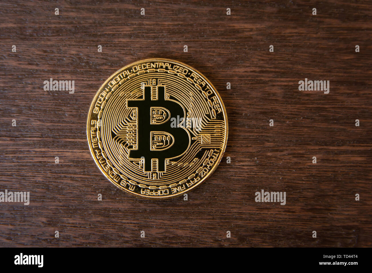 Bitcoin gold coin on dark wood background Stock Photo - Alamy