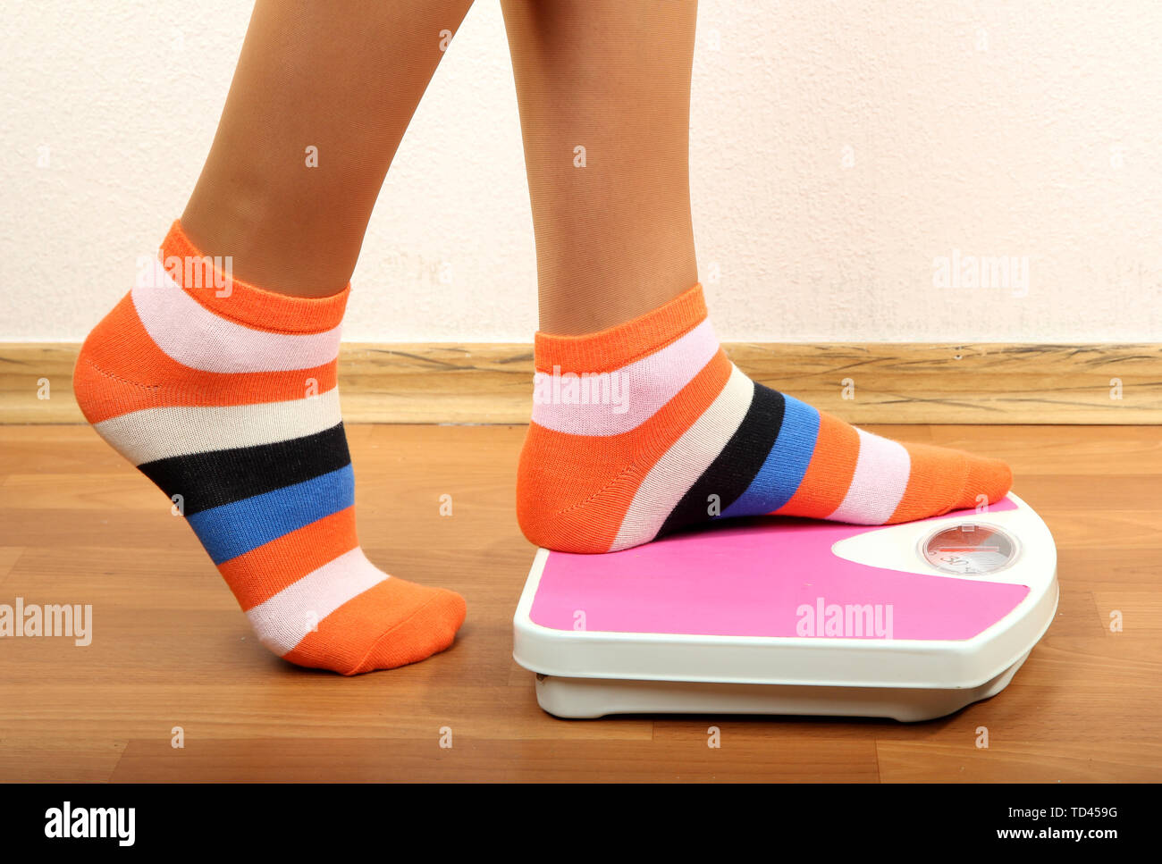 Feet on scales on floor in room Stock Photo - Alamy