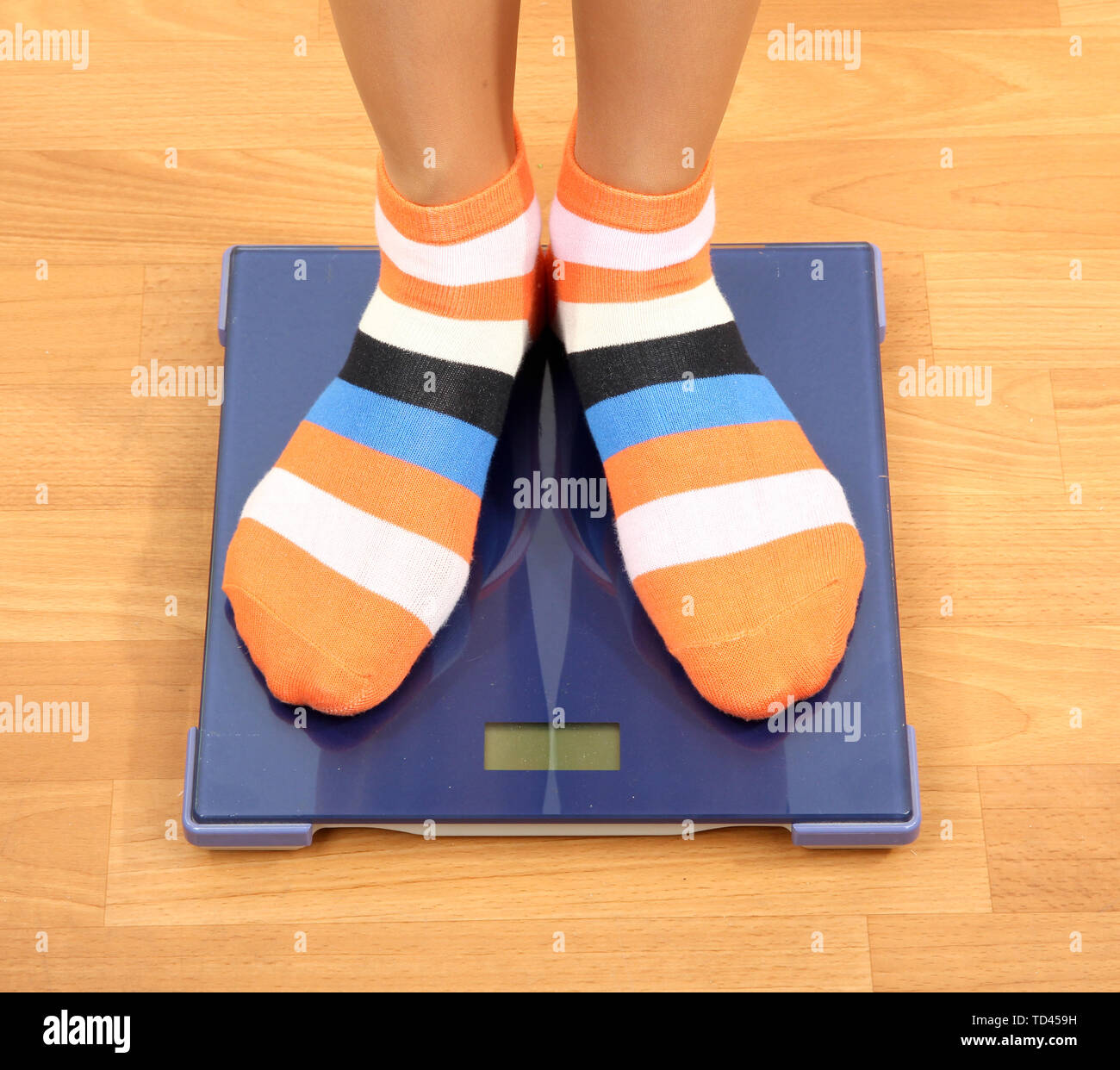 Feet on scales on floor in room Stock Photo - Alamy