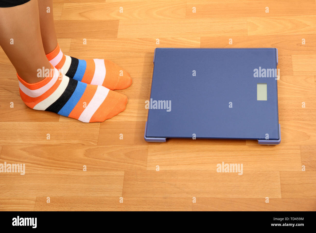 Feet on scales on floor in room Stock Photo - Alamy