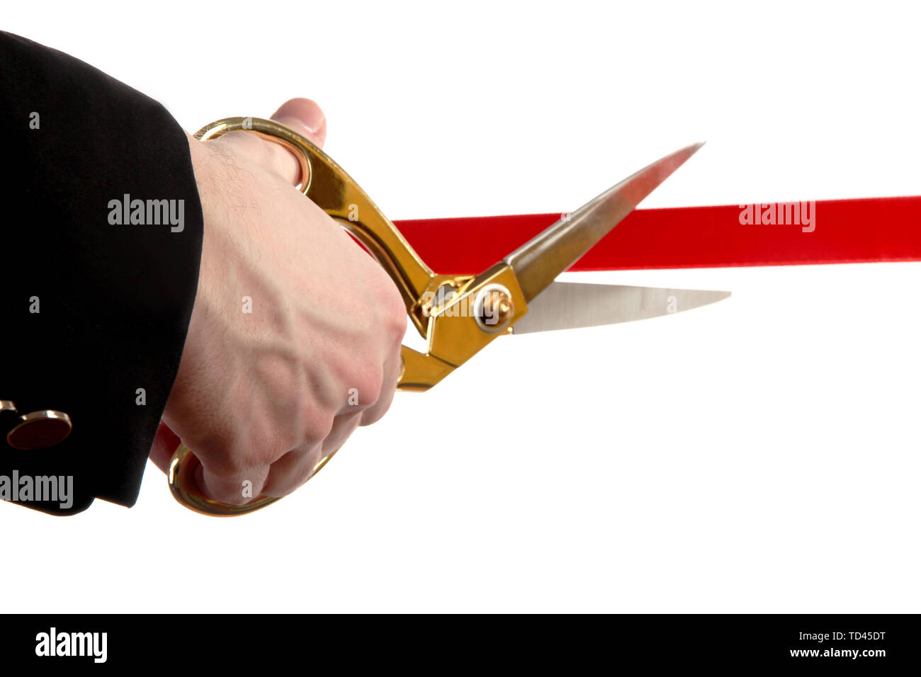 Man's hand cutting red ribbon with pair of scissors isolated on white ...