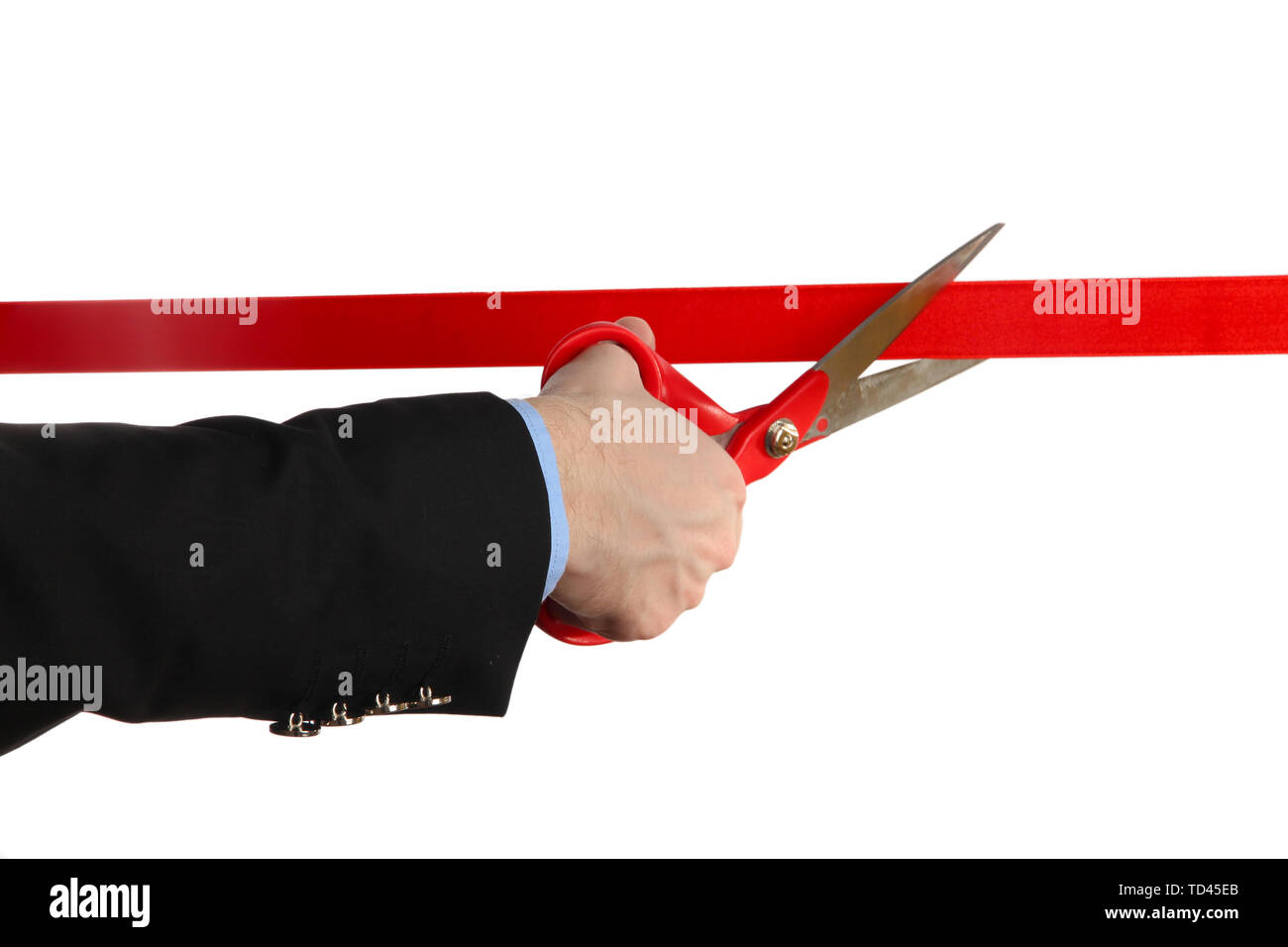 Man's hand cutting red ribbon with pair of scissors isolated on white ...