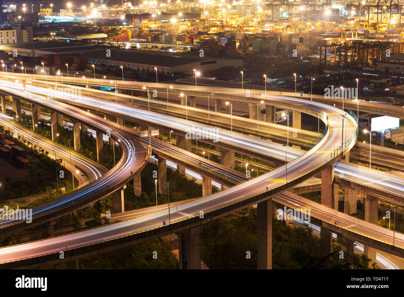Illuminated and elevated expressway and cityscape at night Stock Photo ...