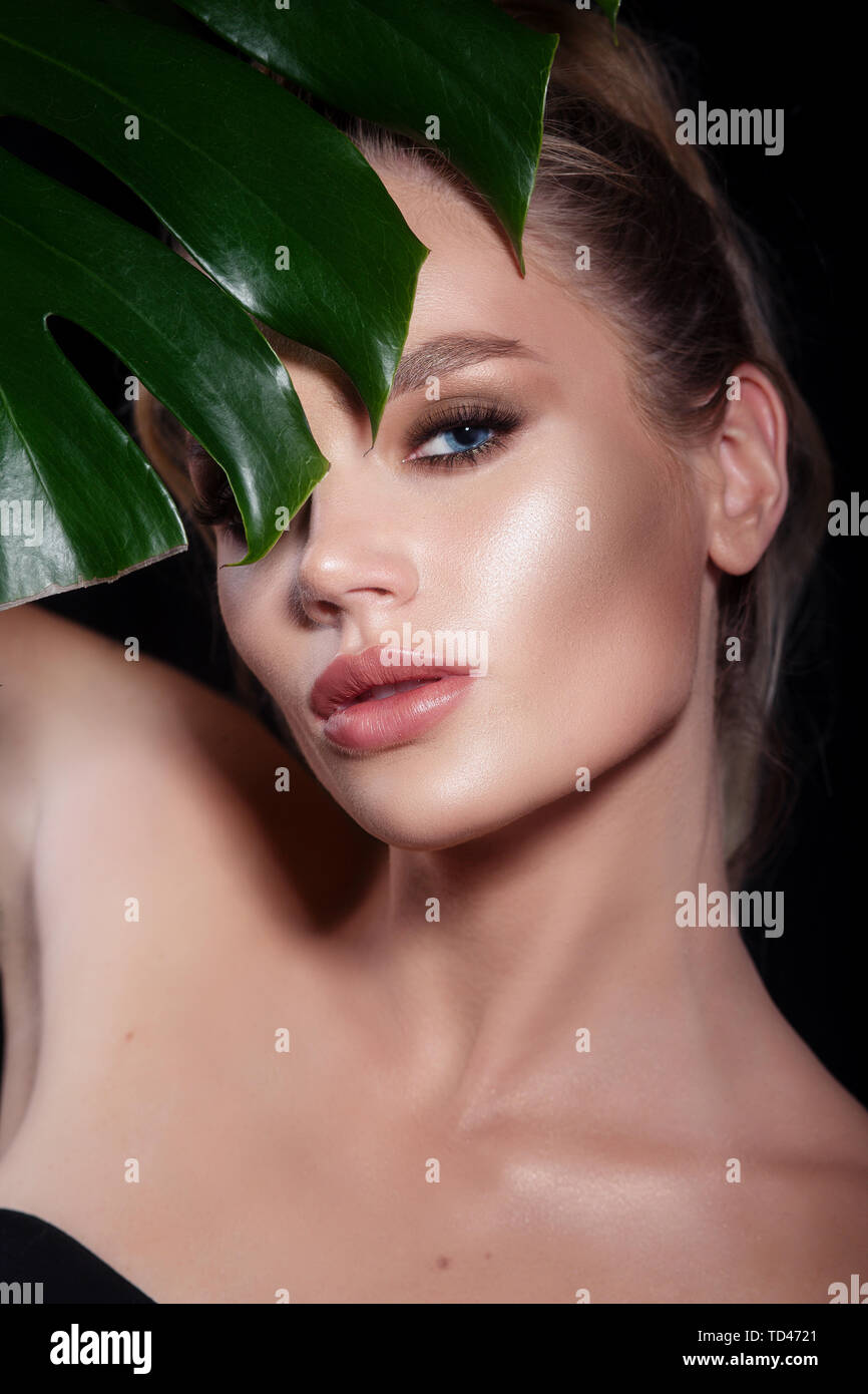 Portrait of young beautiful woman with perfect smooth skin in tropical ...