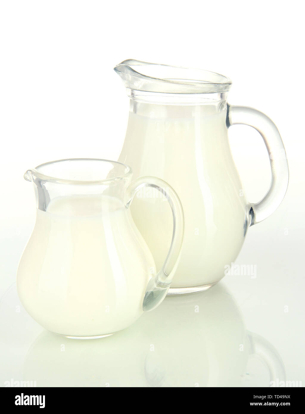 Two jugs of milk isolated on white Stock Photo - Alamy