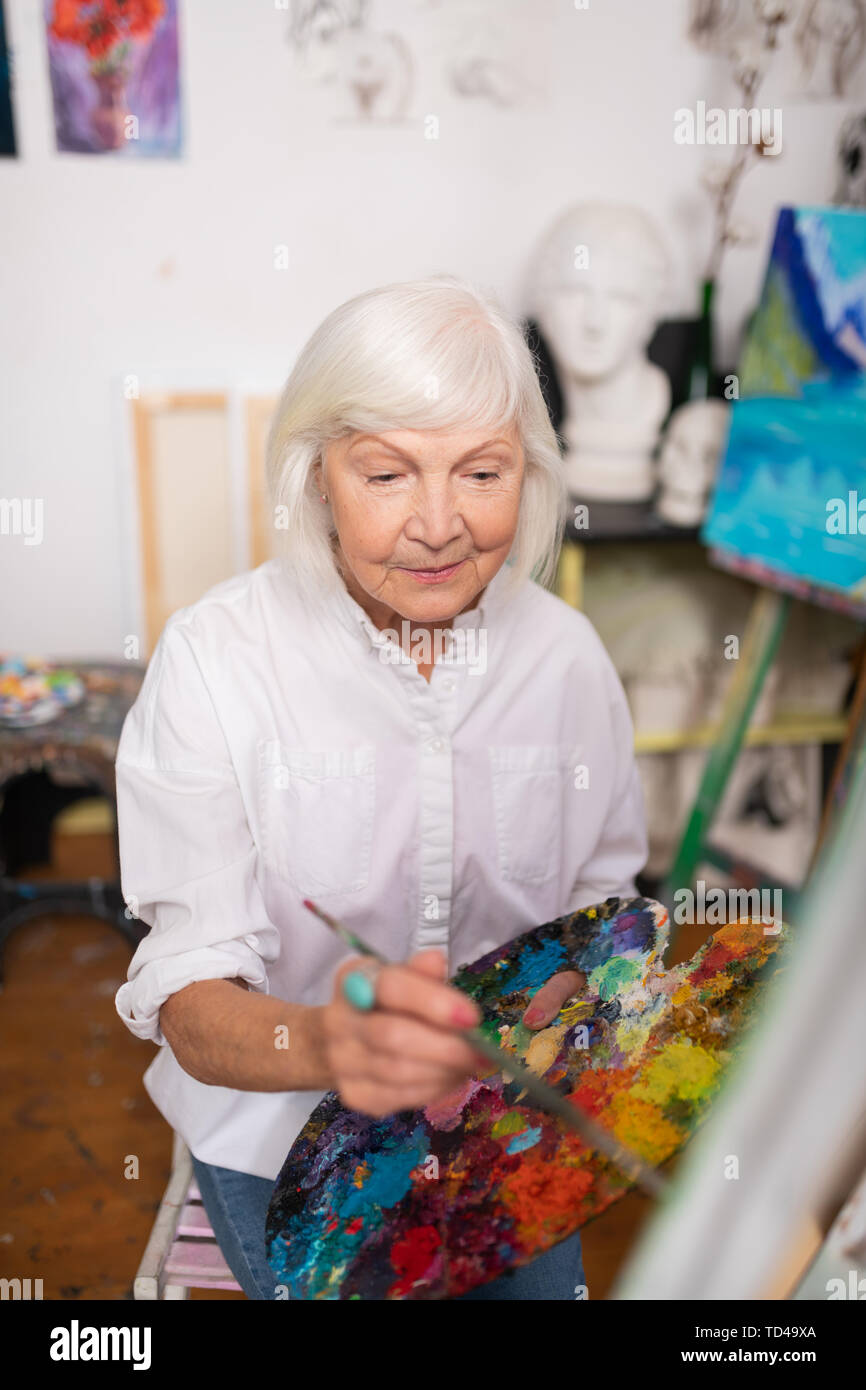 Retired artist. Top view of retired artist wearing white blouse ...