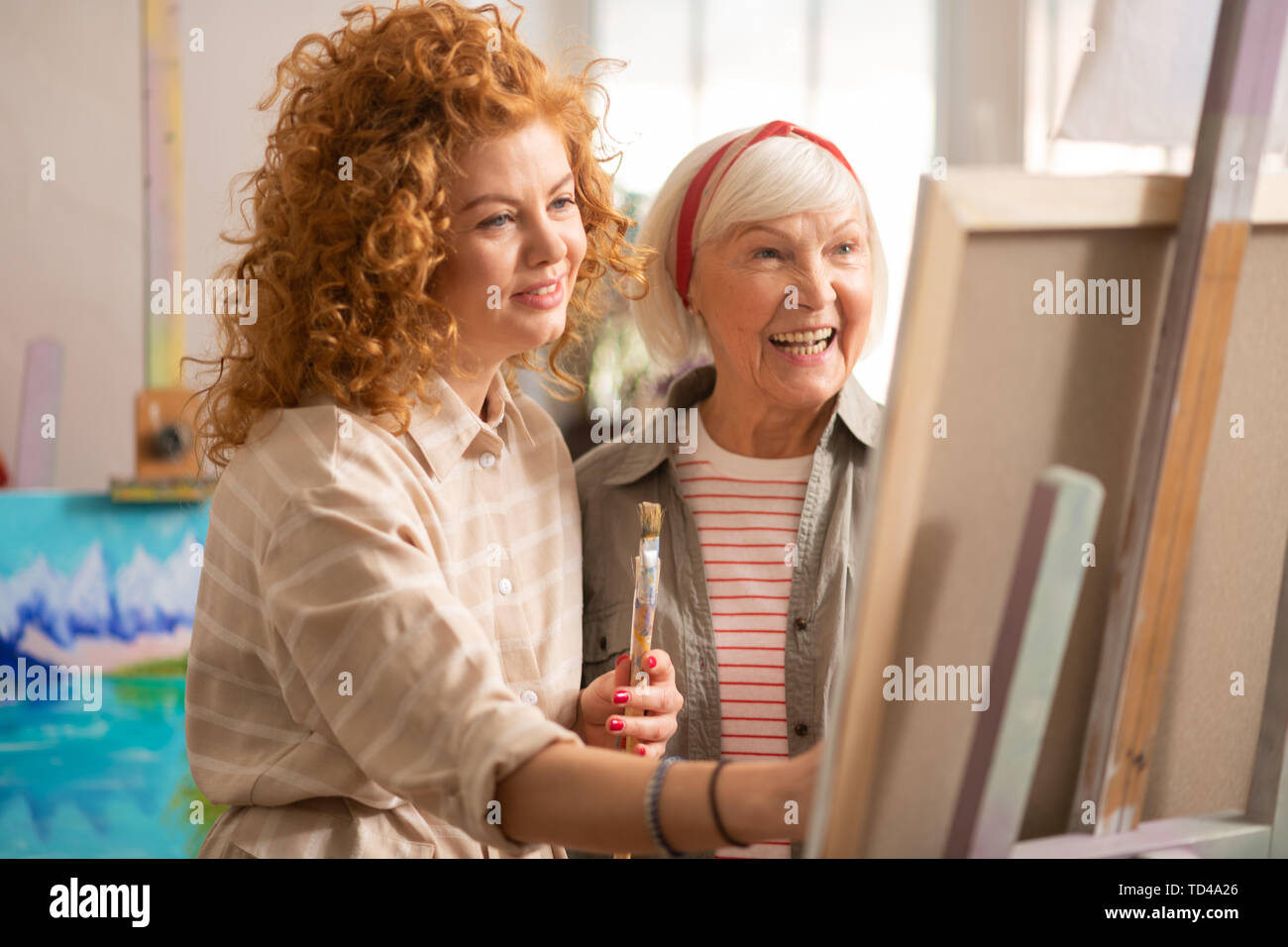 Future artist. Future red-haired artist feeling excited while painting ...