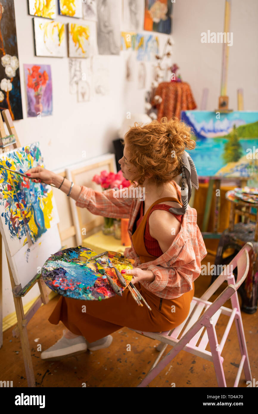 Talented artist. Stylish talented artist with nice hairstyle feeling ...