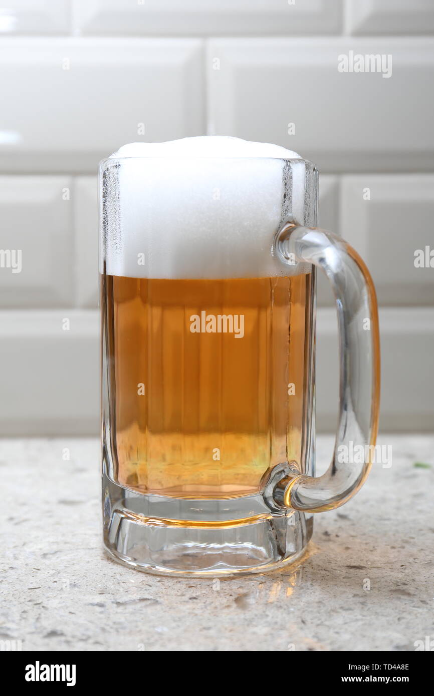 Light colored beer in beer mug with foamy head Stock Photo - Alamy