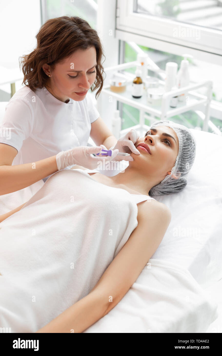 For the chin. Serious hard working cosmetologist focusing on her work ...