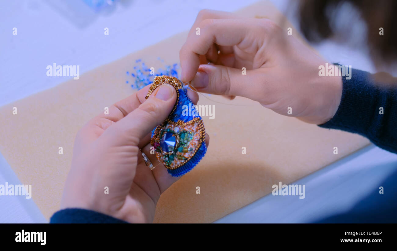 Designer making handmade brooch Stock Photo - Alamy
