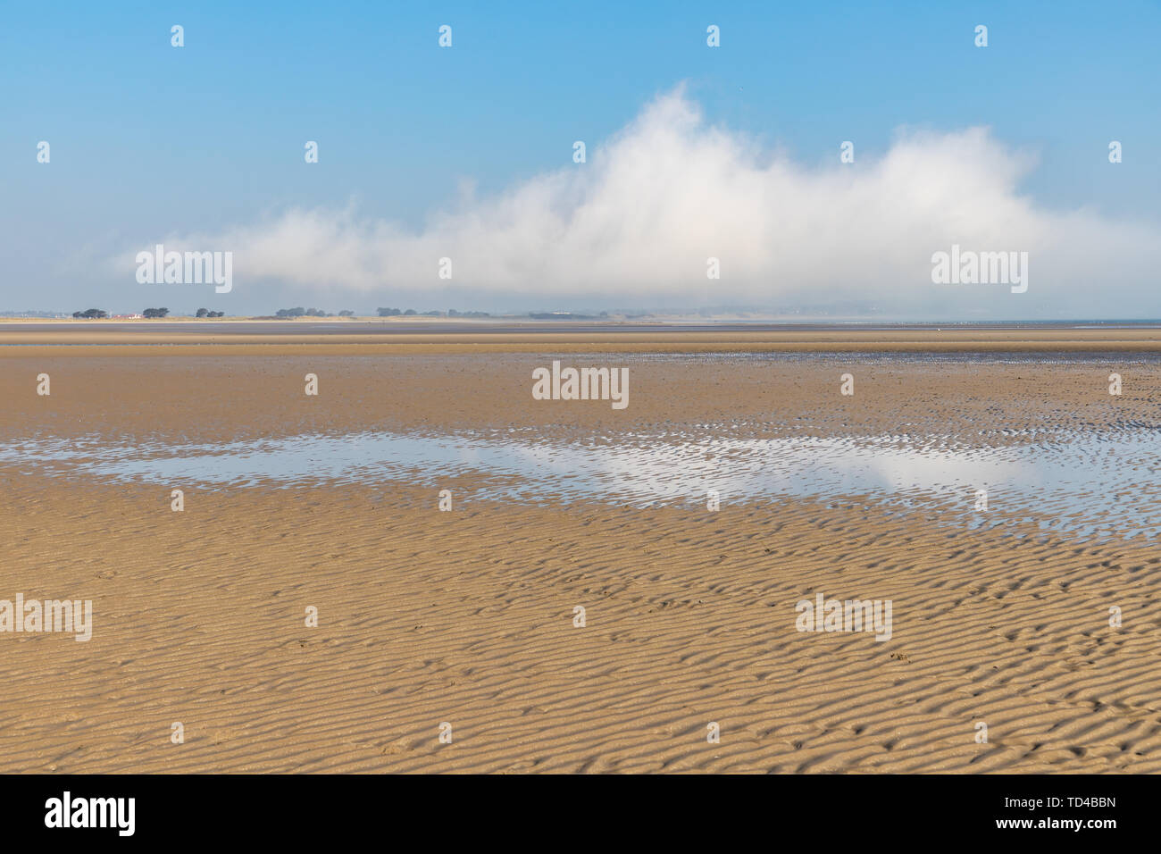 Clouds and sand with reflection in Burrow beach, Sutton, Dublin ...