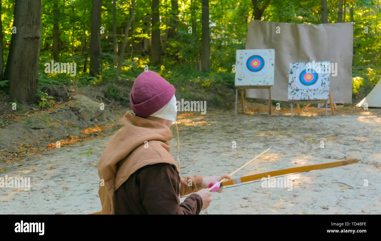 Male archer with wooden bow Stock Photo - Alamy