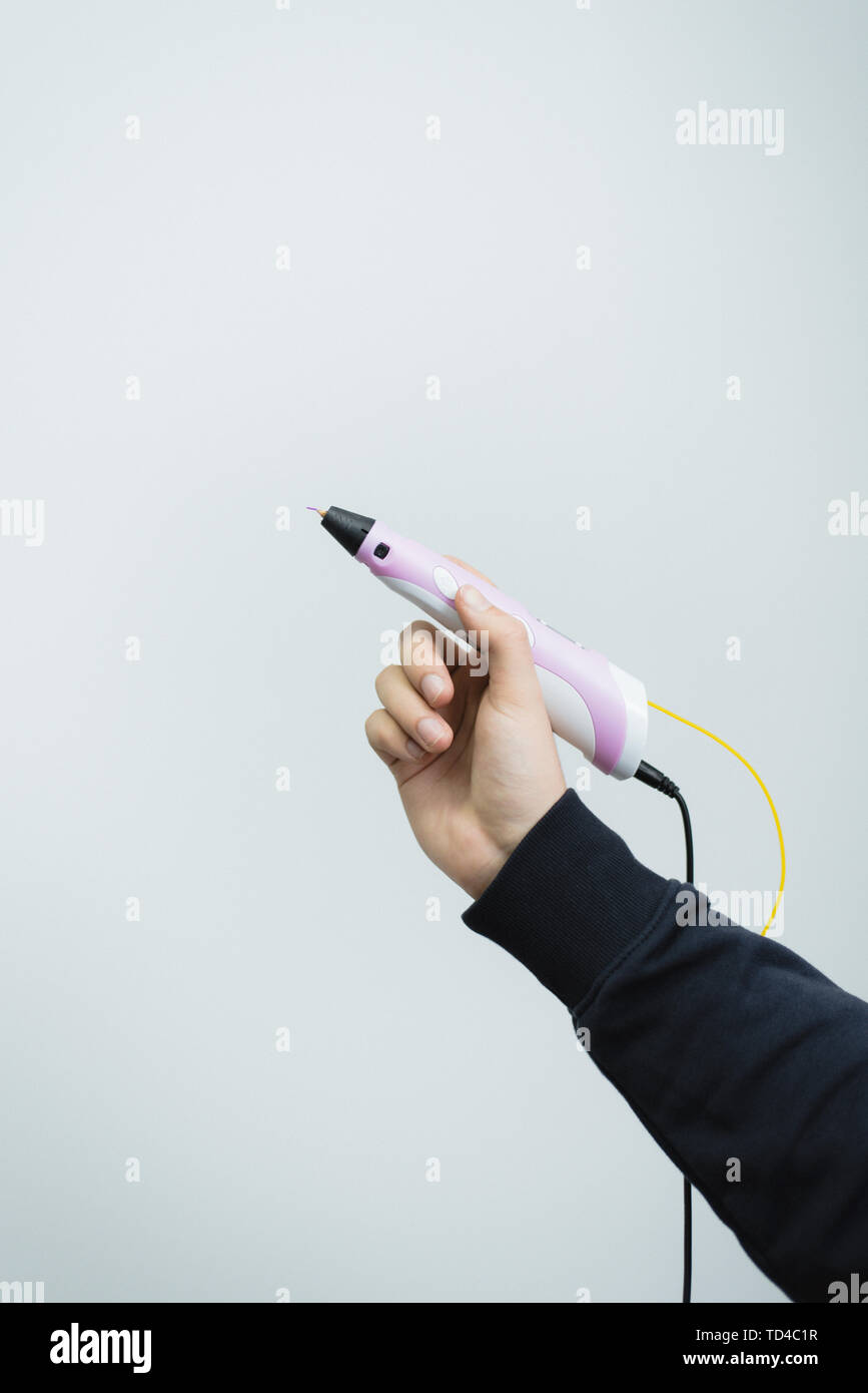 A man holds a 3d pen in his hand. 3d pen in a man's hand. Drawing ...