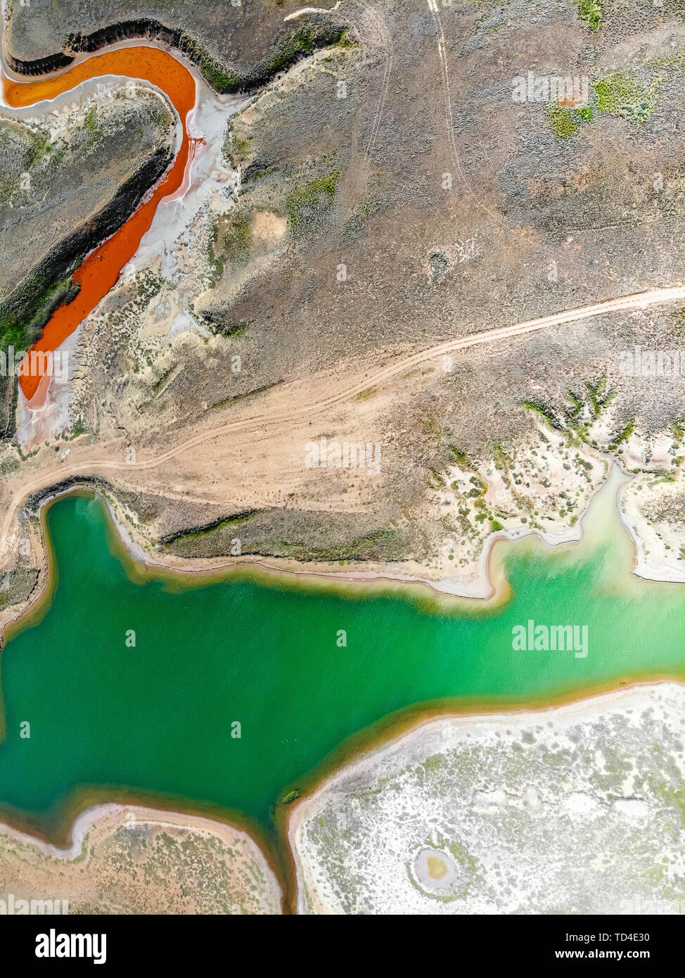 Amazing aerial view of small red water river and green water lake ...