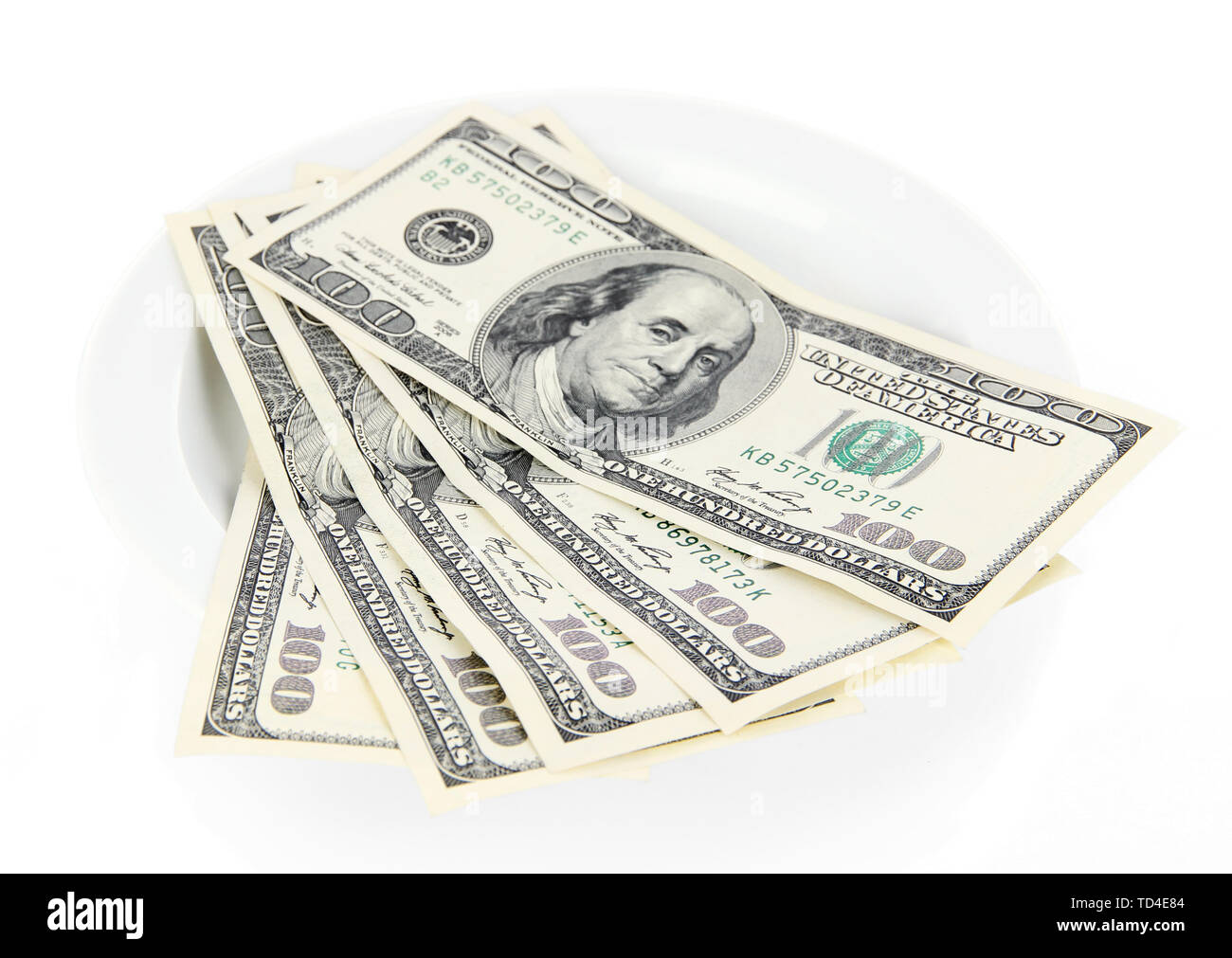 Money on plate isolated on white Stock Photo - Alamy