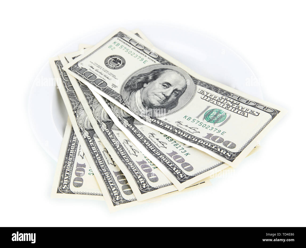 Money on plate isolated on white Stock Photo - Alamy