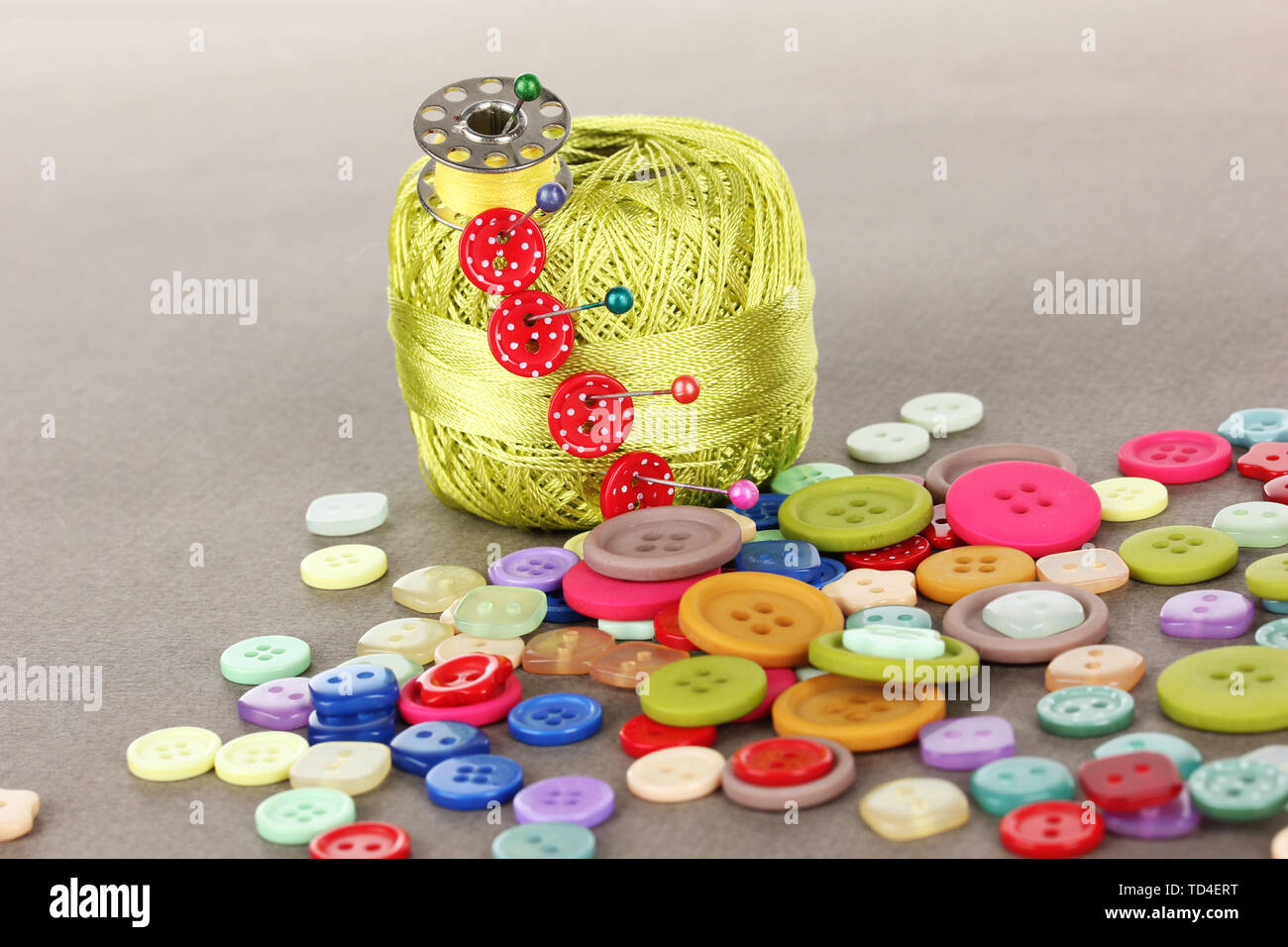 Buttons of different shapes, sizes and colors close-up on gray ...