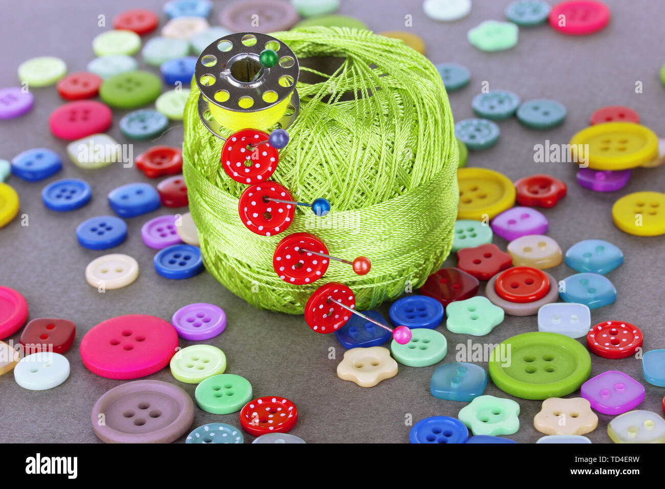 Buttons of different shapes, sizes and colors close-up on gray ...