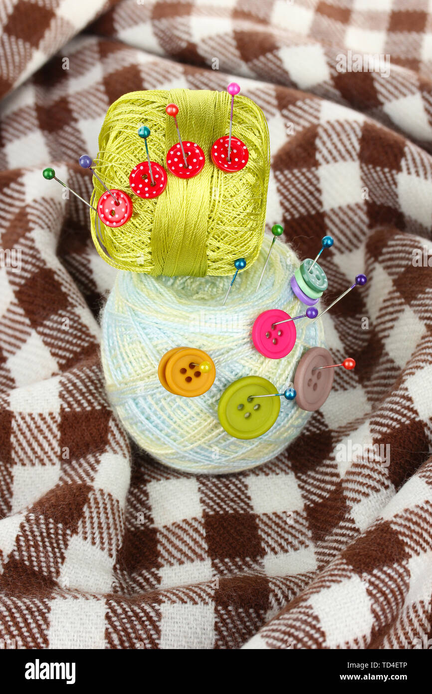 Buttons of different colors, and the two tangle thread Stock Photo - Alamy