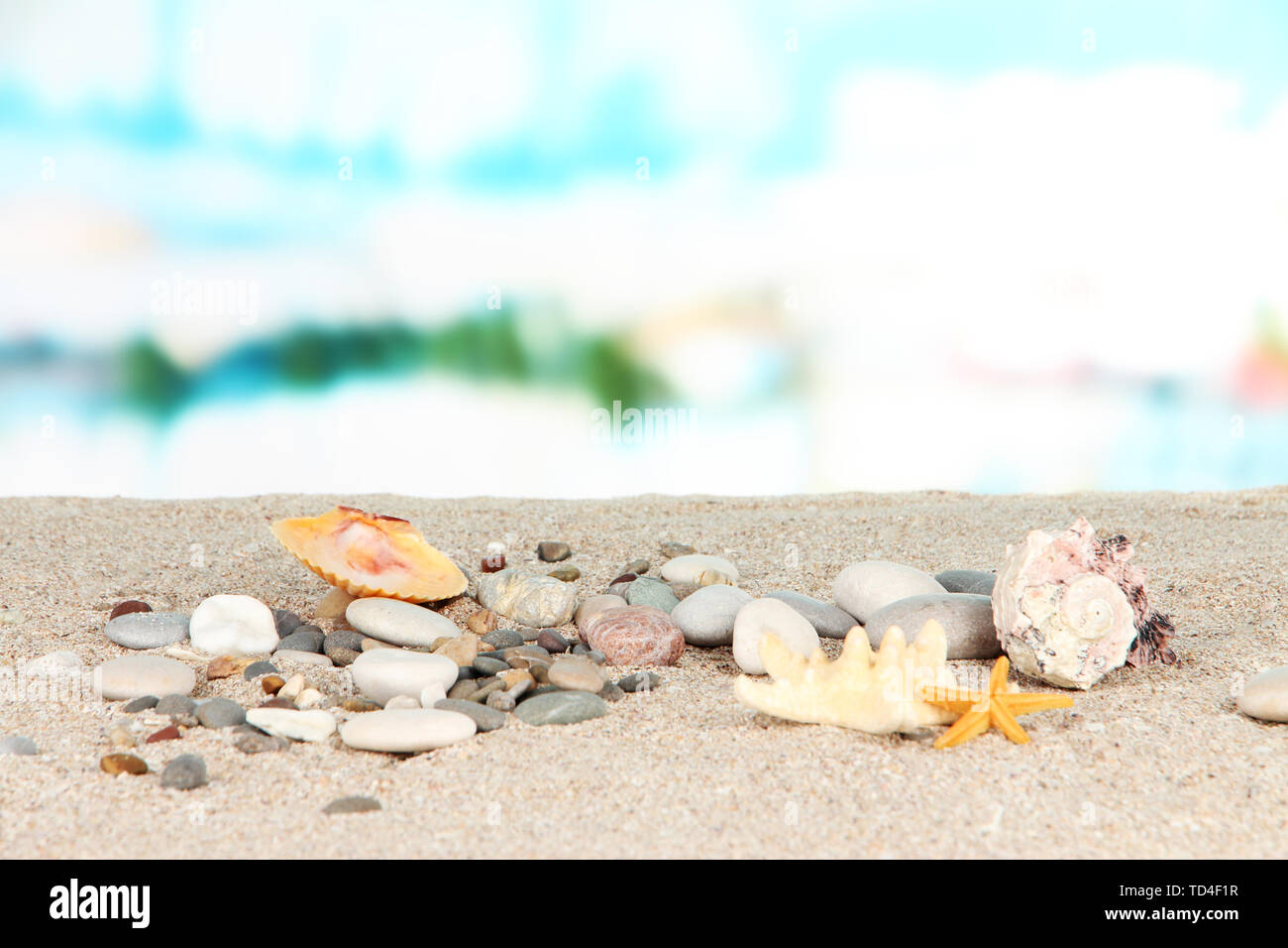 Stones in the sand on the sea background Stock Photo - Alamy
