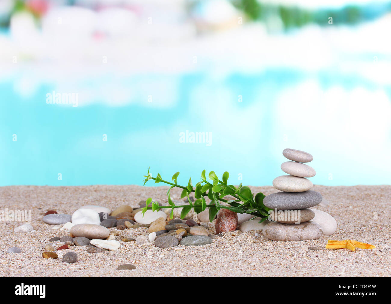 Stones in the sand on the sea background Stock Photo - Alamy