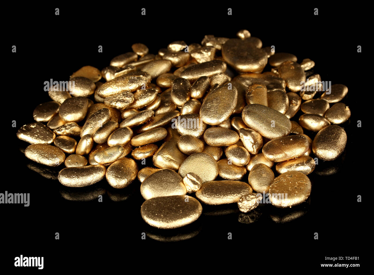 Golden stones isolated on black Stock Photo - Alamy