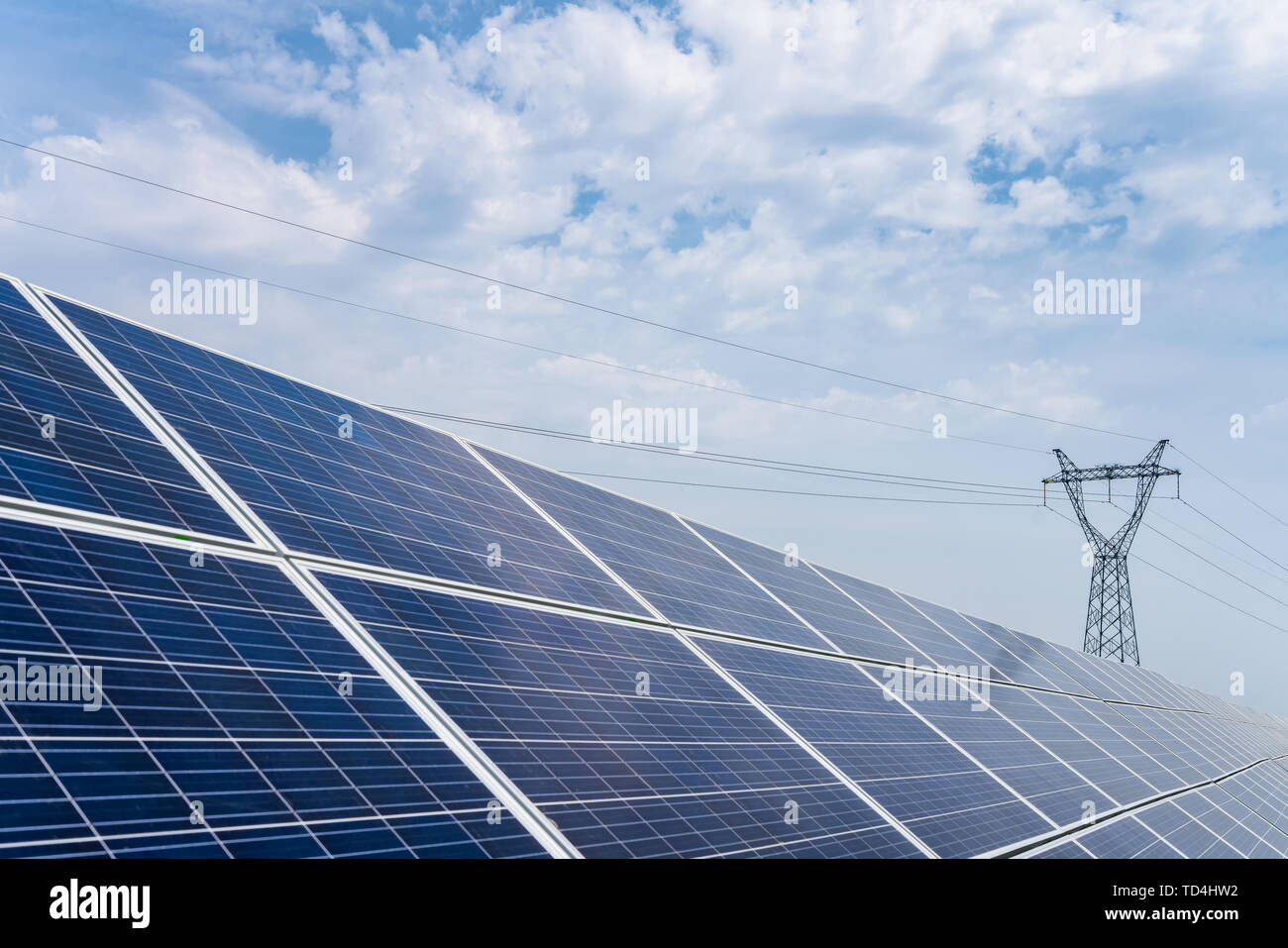 Photovoltaic panels and overhead transmission lines Stock Photo - Alamy