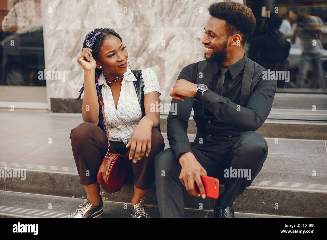 A stylish and beautiful dark-skinned couple in a city Stock Photo - Alamy