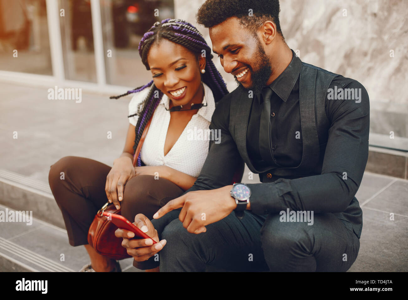 A stylish and beautiful dark-skinned couple in a city Stock Photo - Alamy