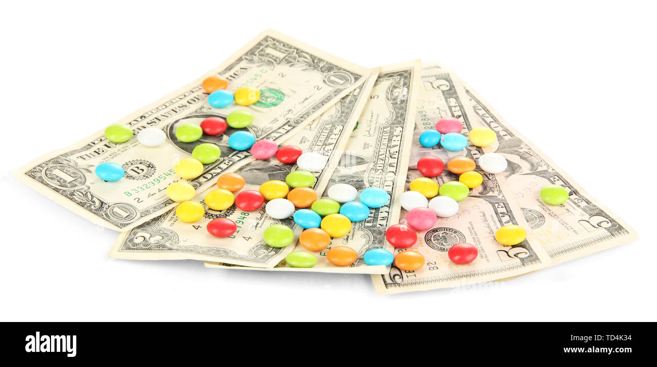 Colorful candies on dollar banknotes isolated on white Stock Photo - Alamy