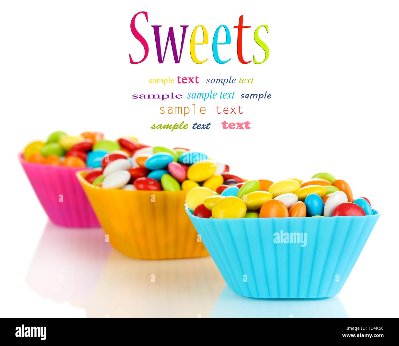 Colorful candies in cupcake cases isolated on white Stock Photo - Alamy
