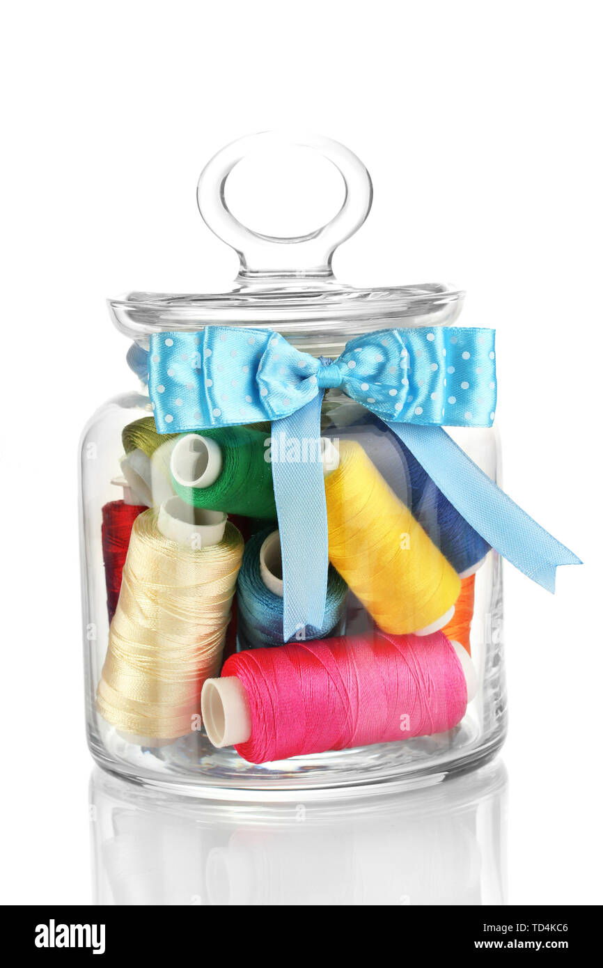 Glass jar containing various colored thread isolated on white Stock ...