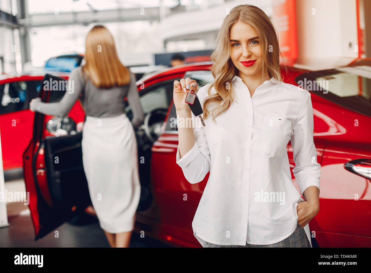 Women red car showroom hi-res stock photography and images - Alamy