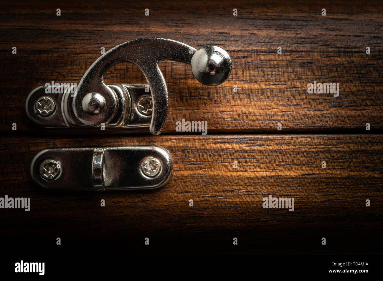 A close-up frontal view of a fancy silver-color sliding latch lock for ...