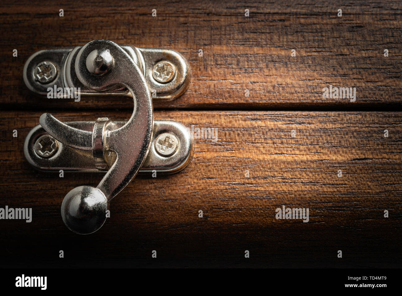 A close-up frontal view of a fancy silver-color sliding latch lock for ...