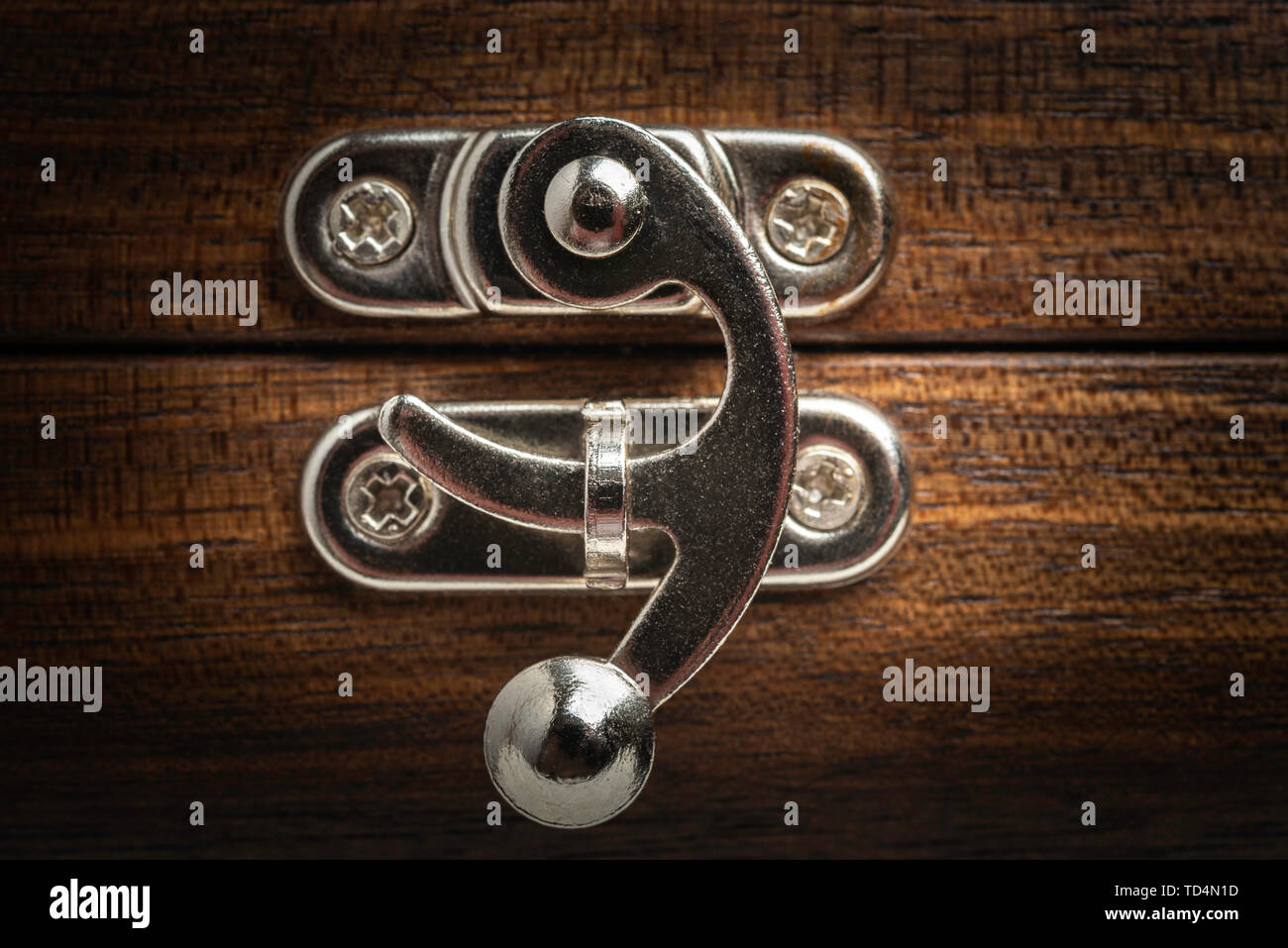 A close-up frontal view of a fancy silver-color sliding latch lock for ...