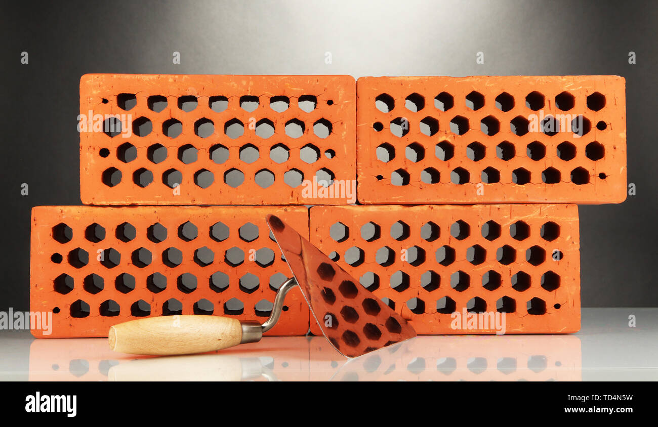 Metal tool for building and bricks on black background Stock Photo - Alamy