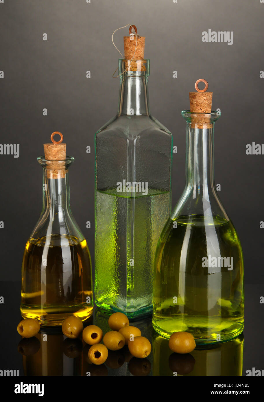 Original glass bottles with oil isolated on black Stock Photo - Alamy