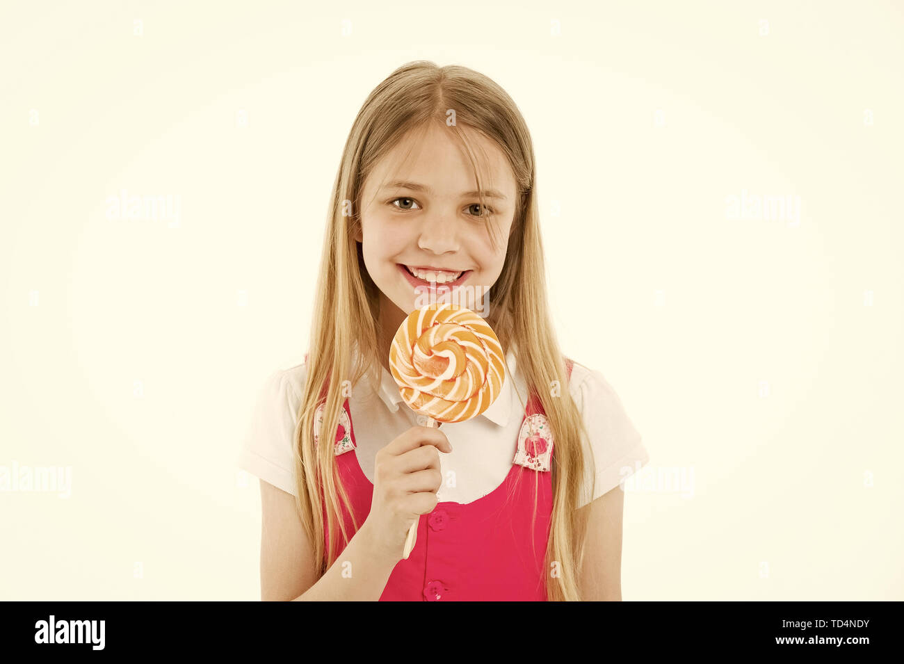 Girl eating big candy on stick or lollipop. Sweet tooth concept. Girl ...