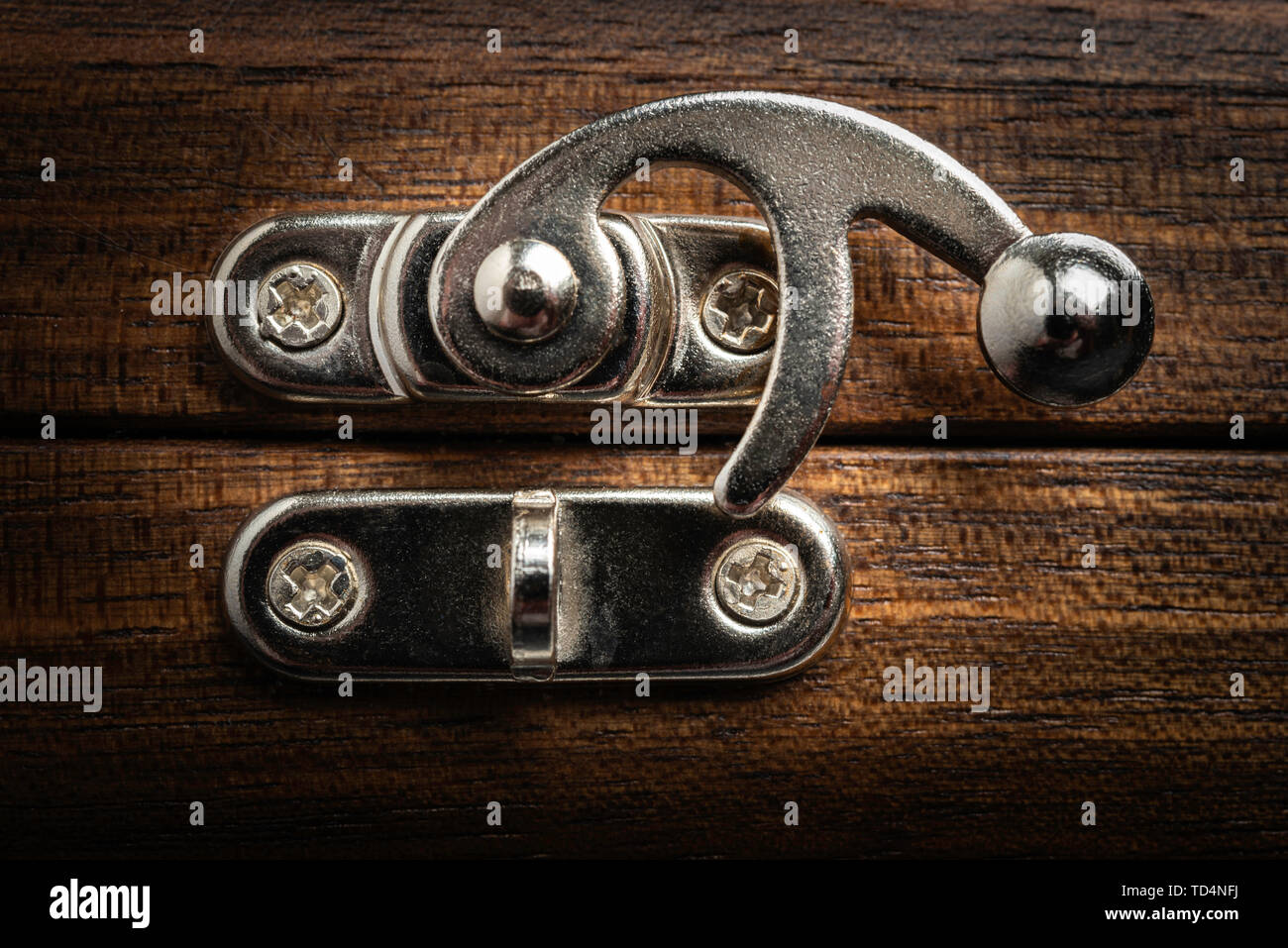 A close-up frontal view of a fancy silver-color sliding latch lock for ...